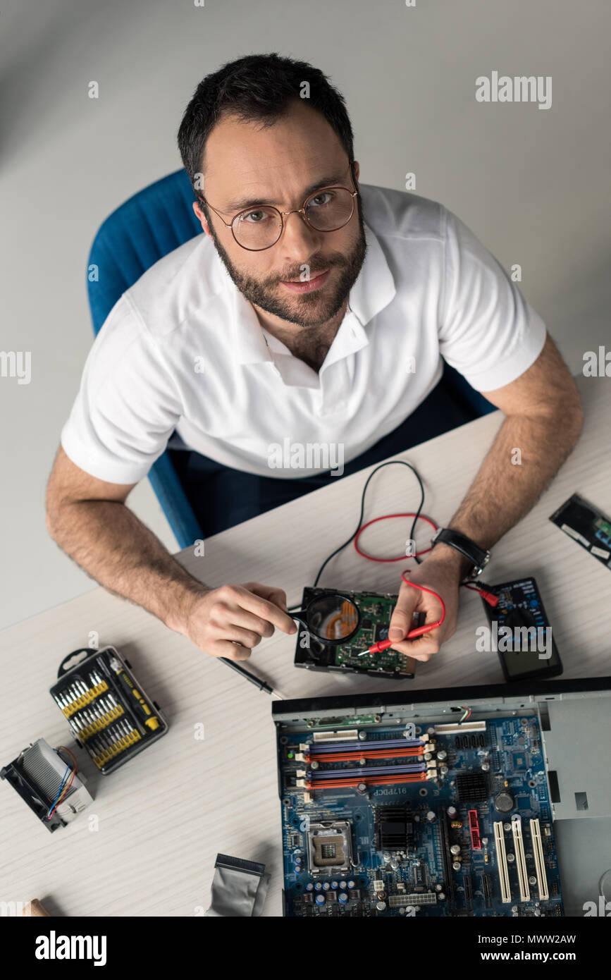 man using multimeter while testing hard disk drive Stock Photo - Alamy