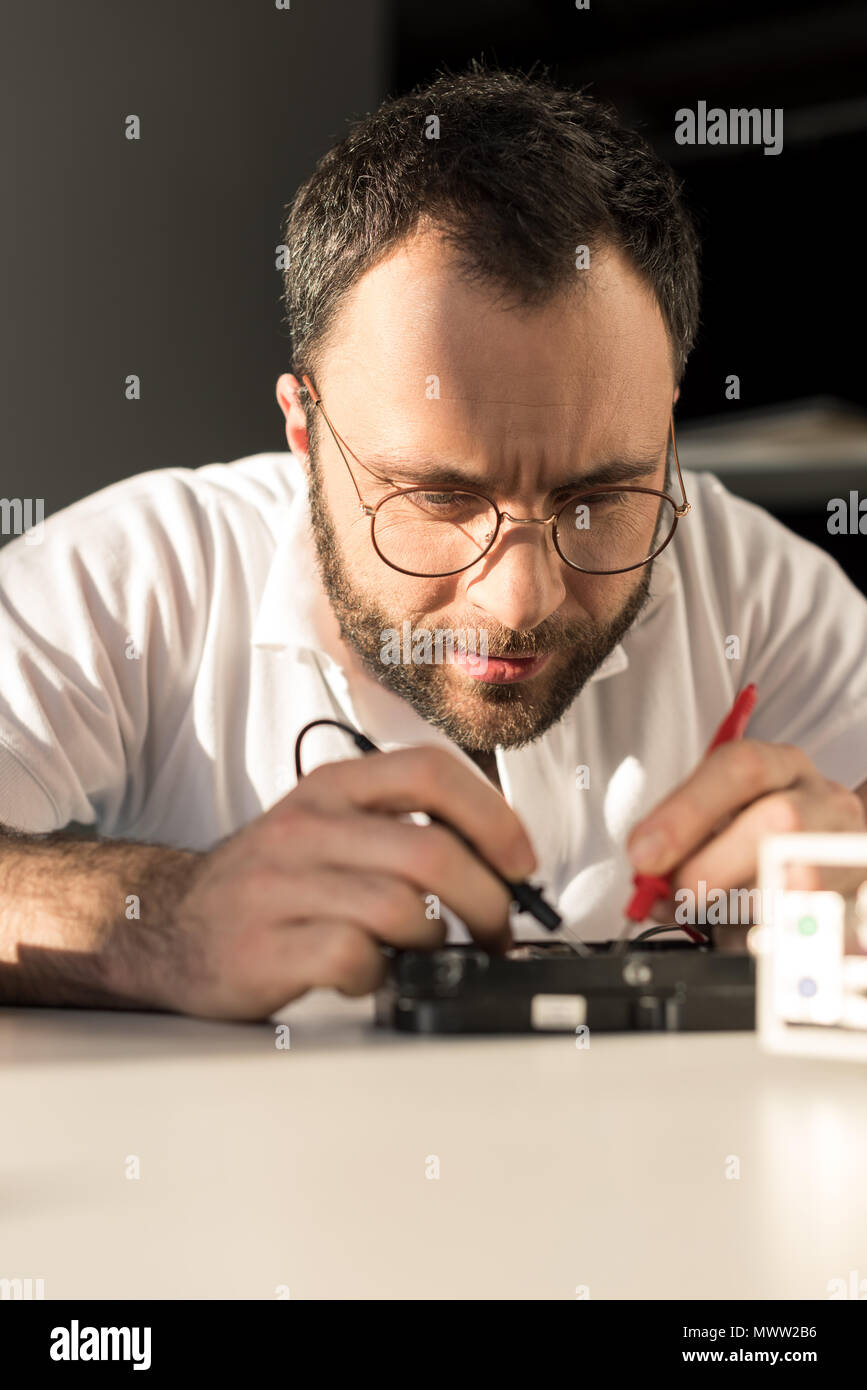 man using multimeter while testing hard disk drive Stock Photo - Alamy