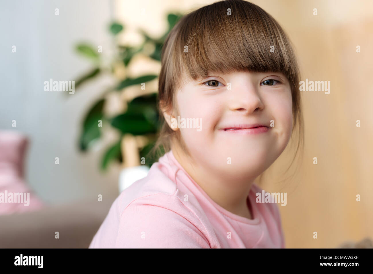 Portrait of smiling kid with down syndrome Stock Photo - Alamy
