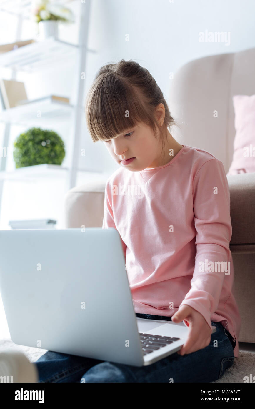 Kid with down syndrome using laptop Stock Photo - Alamy