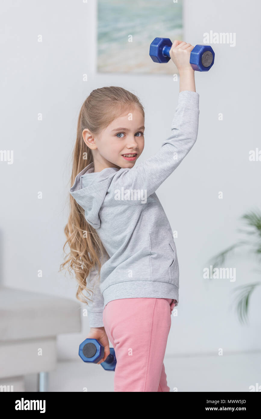 beautiful little child working out with dumbbells Stock Photo - Alamy