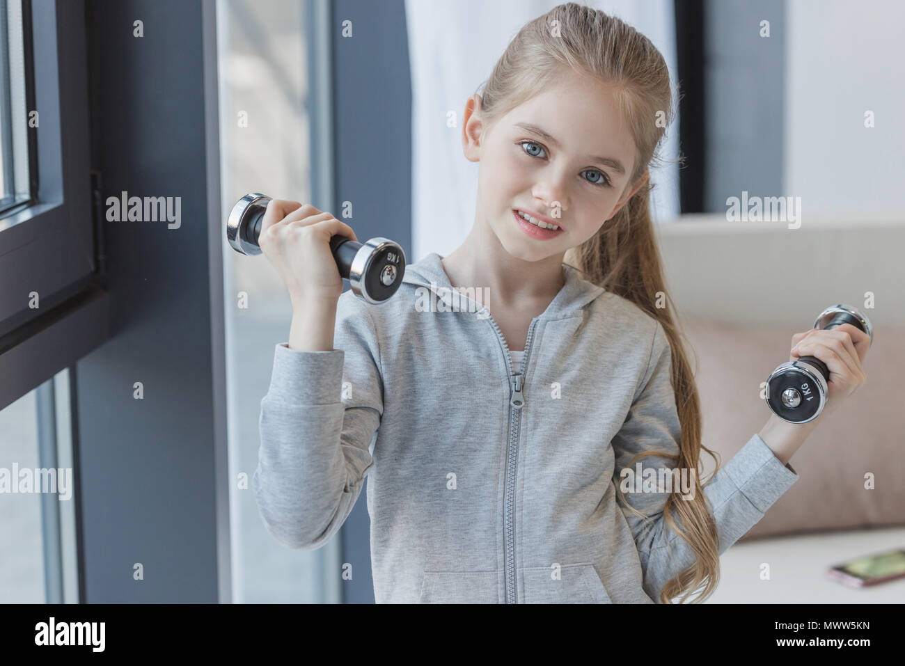adorable little child working out with dumbbells Stock Photo - Alamy