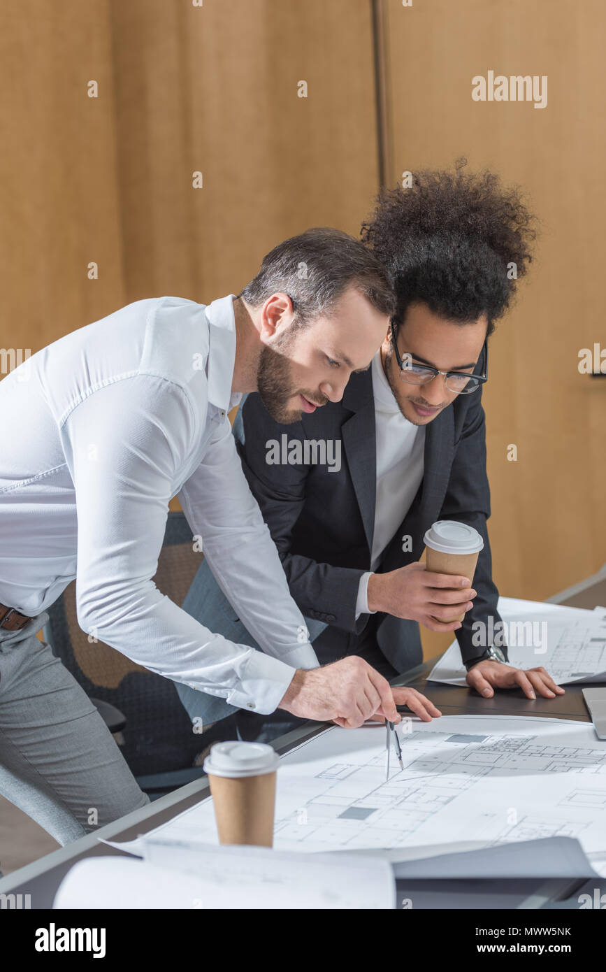 architects using compass for building plans at office Stock Photo - Alamy