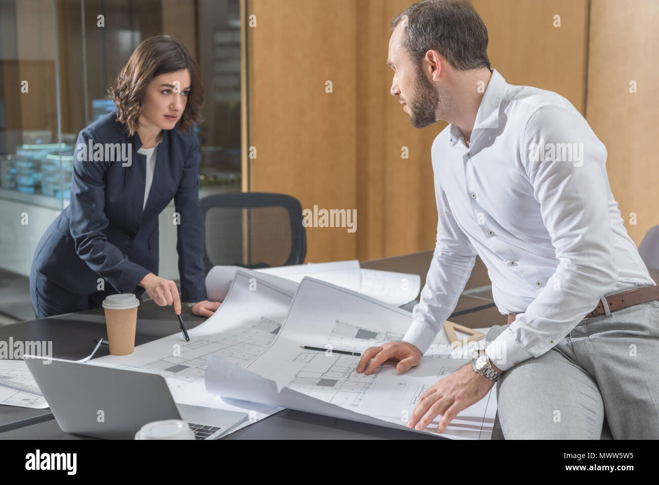 architects discussing building plans together at modern office Stock ...
