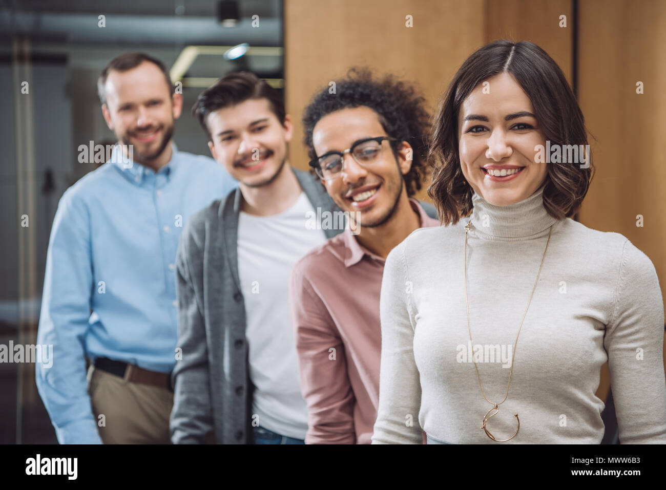 group of successful businesspeople standing in row and looking at ...