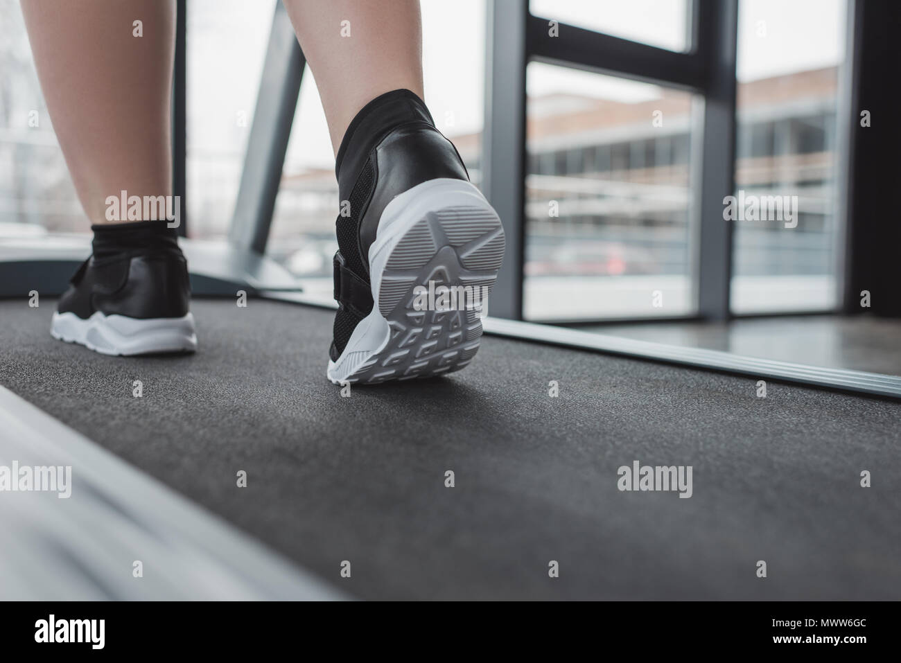 Close-up view overweight girl feet on treadmill in gym Stock Photo - Alamy