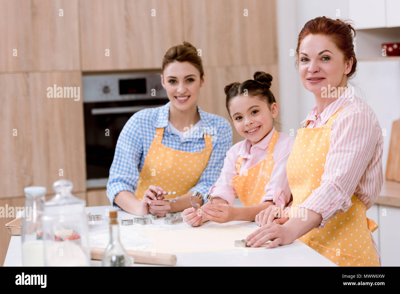 three generations of women cooking together at kitchen Stock Photo - Alamy