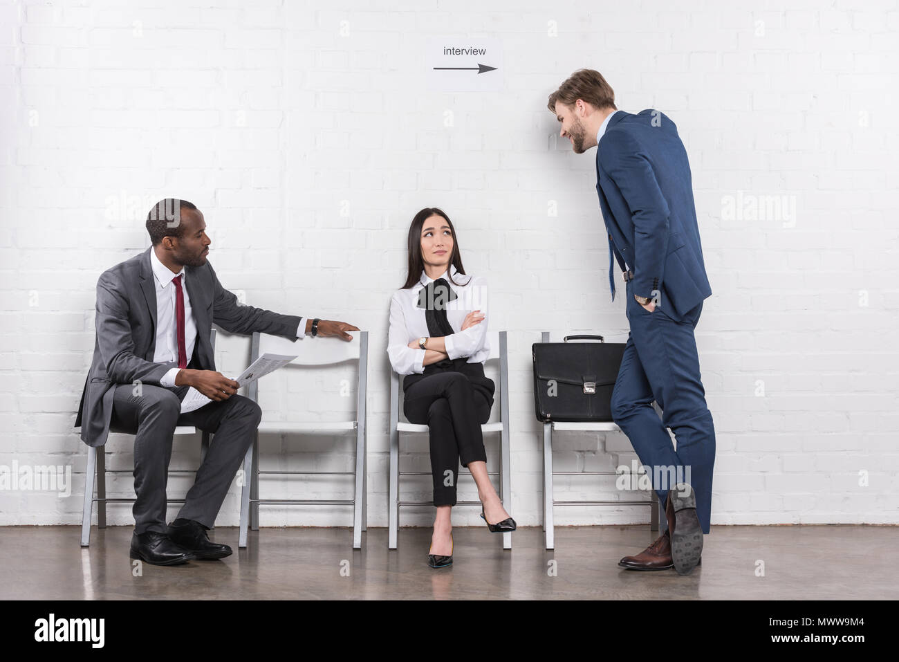 multiethnic business people having conversation while waiting for job ...
