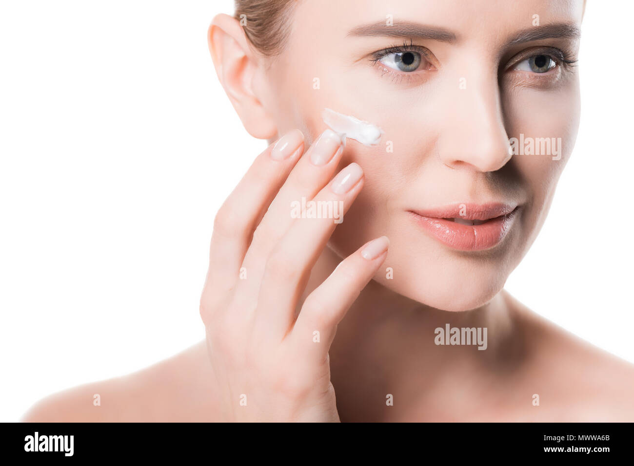 Female applying cream on face isolated on white Stock Photo - Alamy