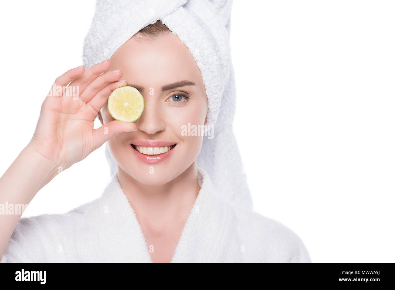 Female with clean skin holding slice of lime isolated on white Stock ...