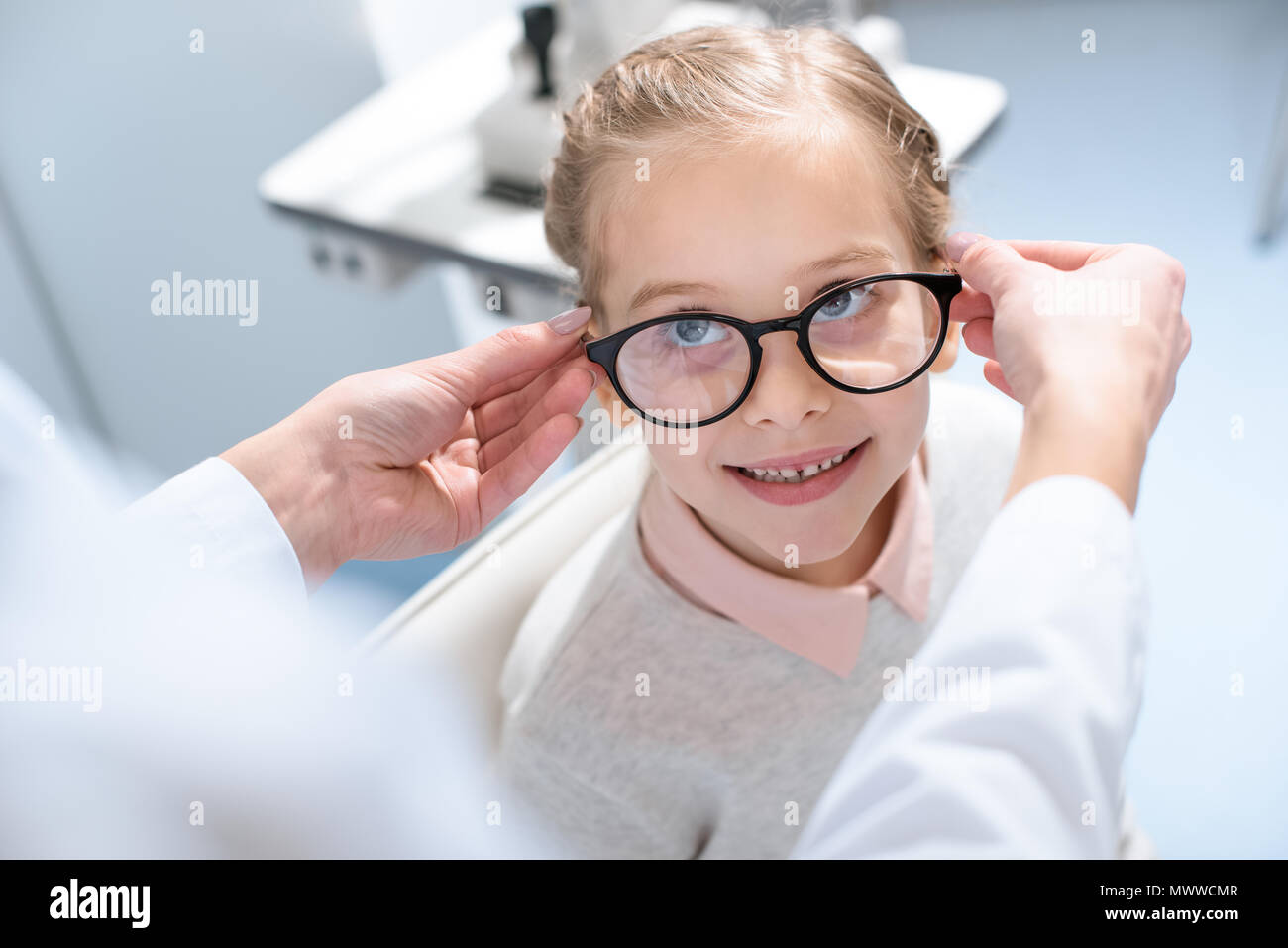 oculist and little child in glasses in optical clinic Stock Photo - Alamy