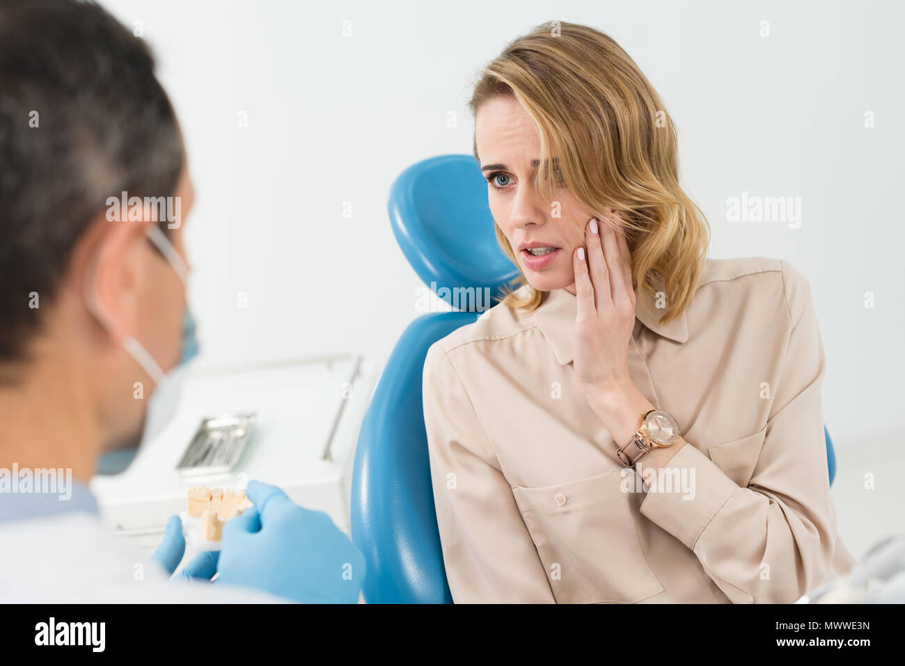 Female patient suffering from toothache in modern dental clinic Stock ...