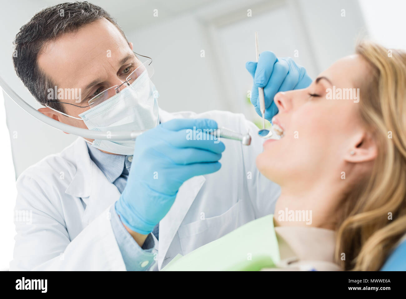 Doctor treats patient teeth in modern dental clinic Stock Photo - Alamy