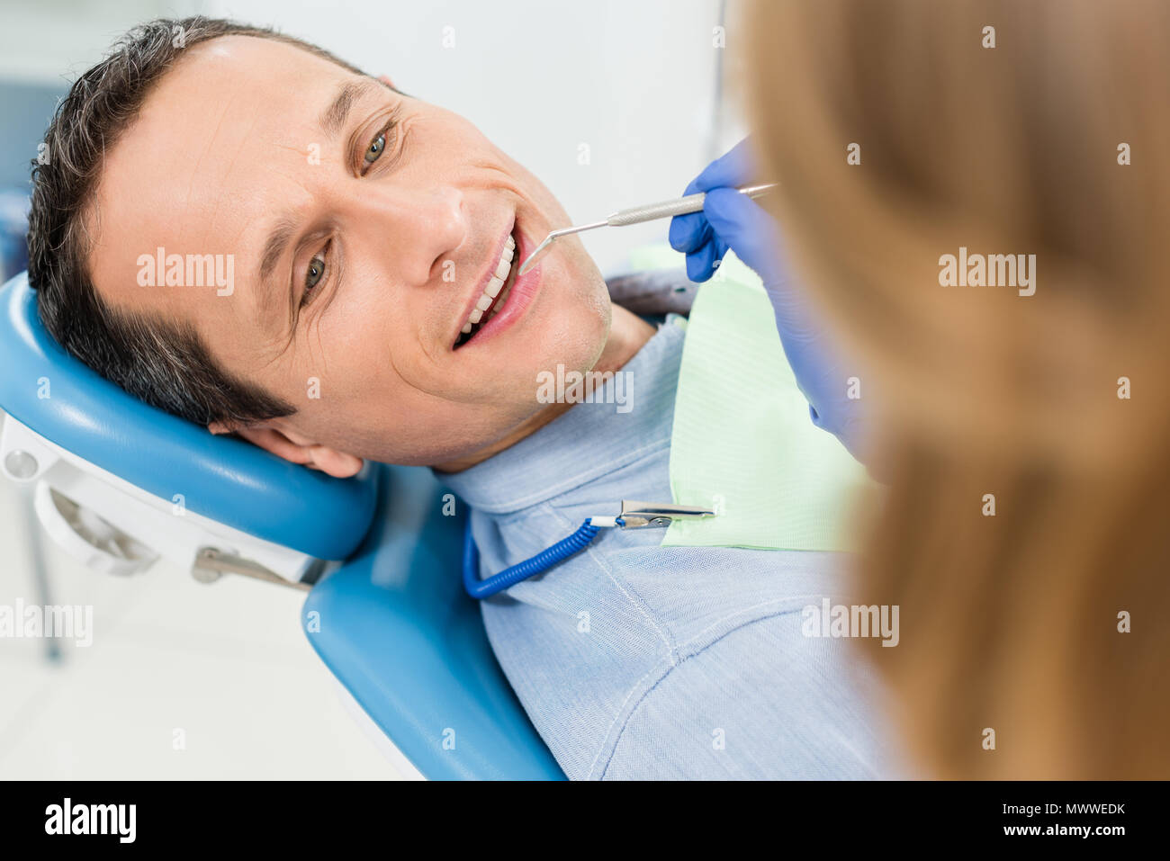 Dentist checking patient teeth in modern clinic Stock Photo - Alamy