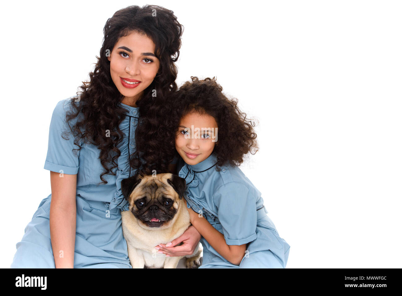 mother and daughter with adorable pug looking at camera isolated on ...