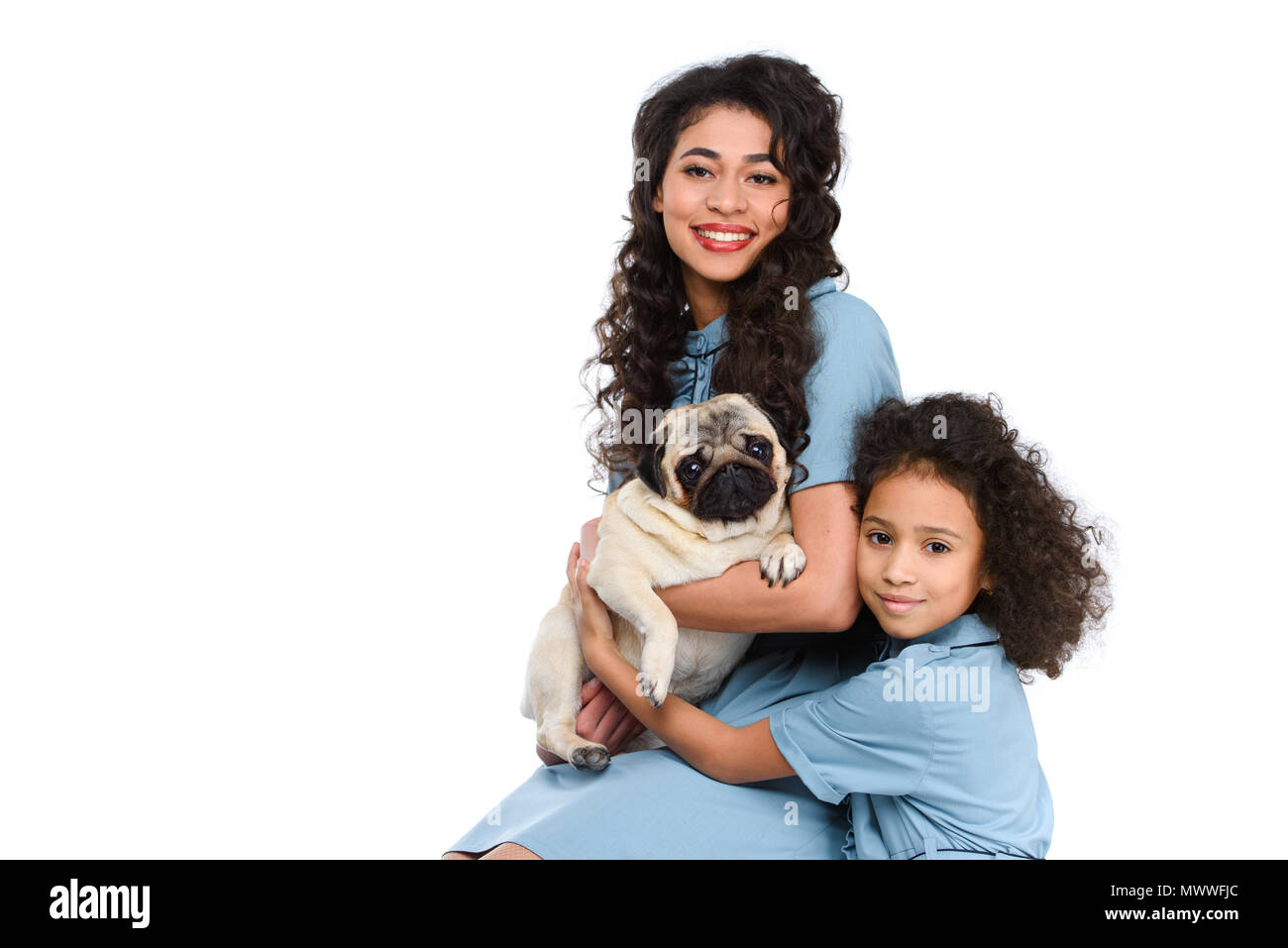 mother and daughter embracing adorable pug isolated on white Stock ...