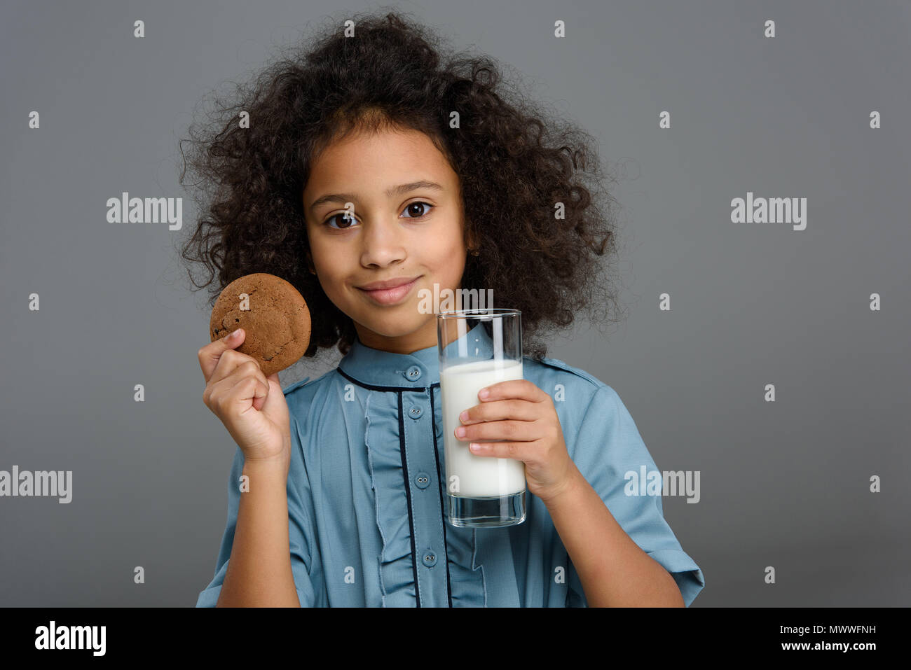 happy african american child with glass of milk and cookie isolated on ...