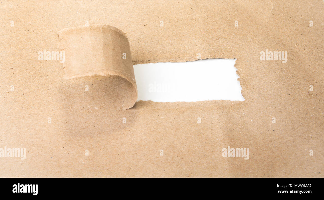 Blank torn brown paper revealing new challenges Stock Photo - Alamy