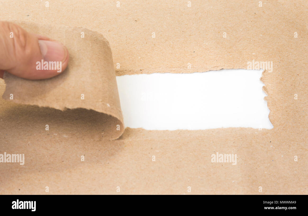 Blank torn brown paper revealing new challenges Stock Photo - Alamy