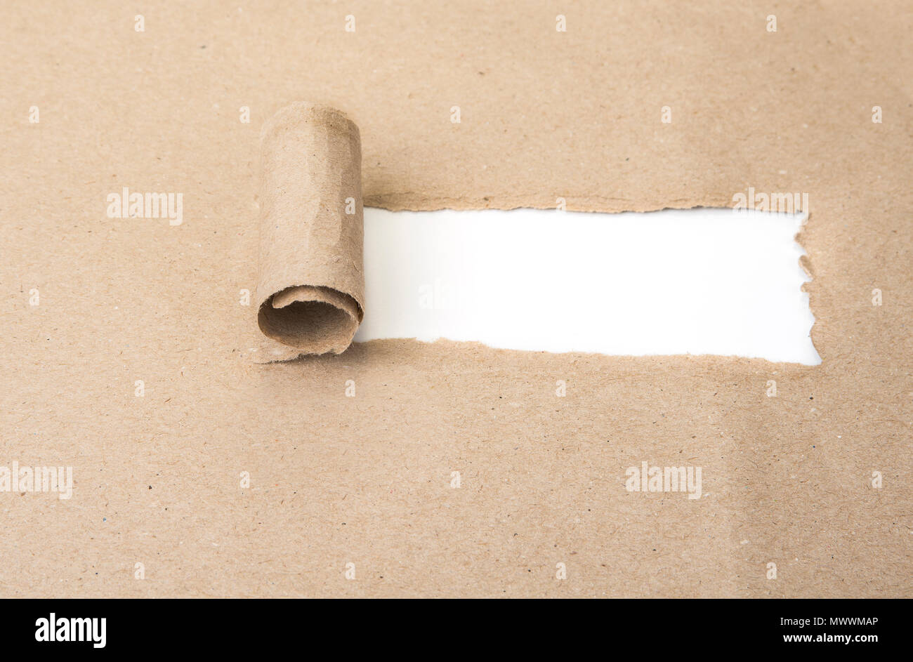 Blank torn brown paper revealing new challenges Stock Photo - Alamy