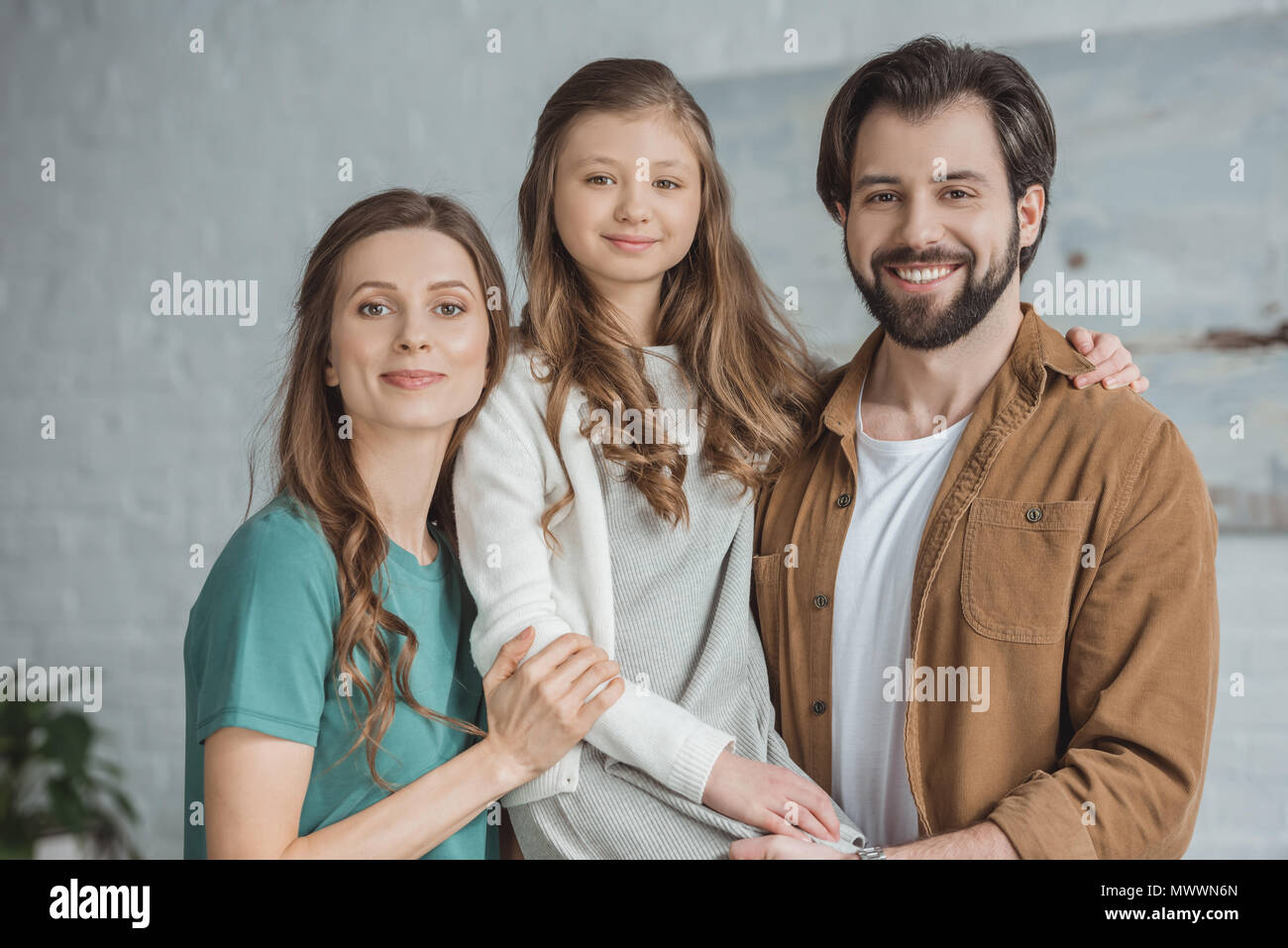happy smiling family looking at camera at home Stock Photo - Alamy