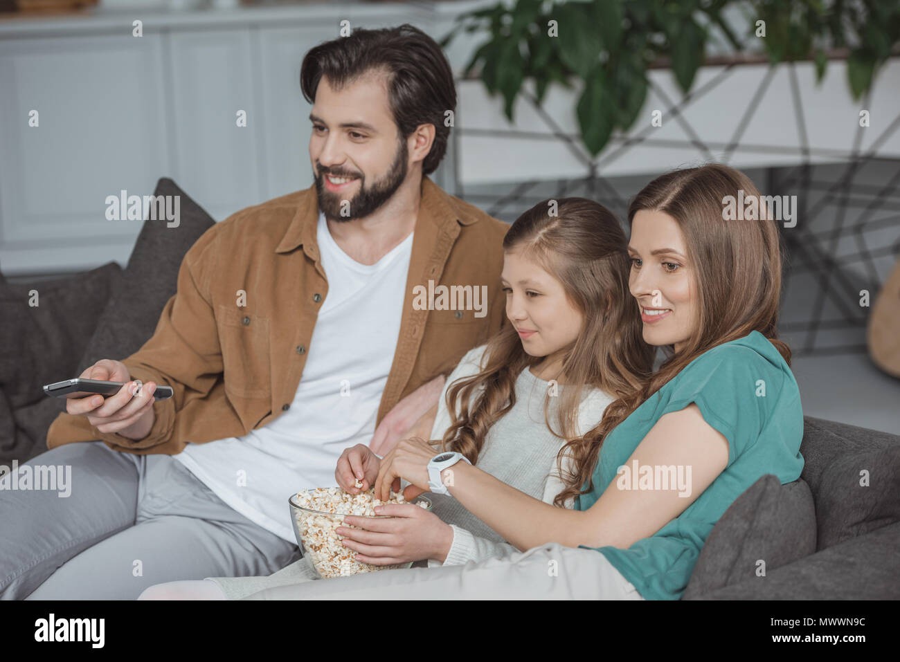 Child watching tv with adults hi-res stock photography and images - Alamy
