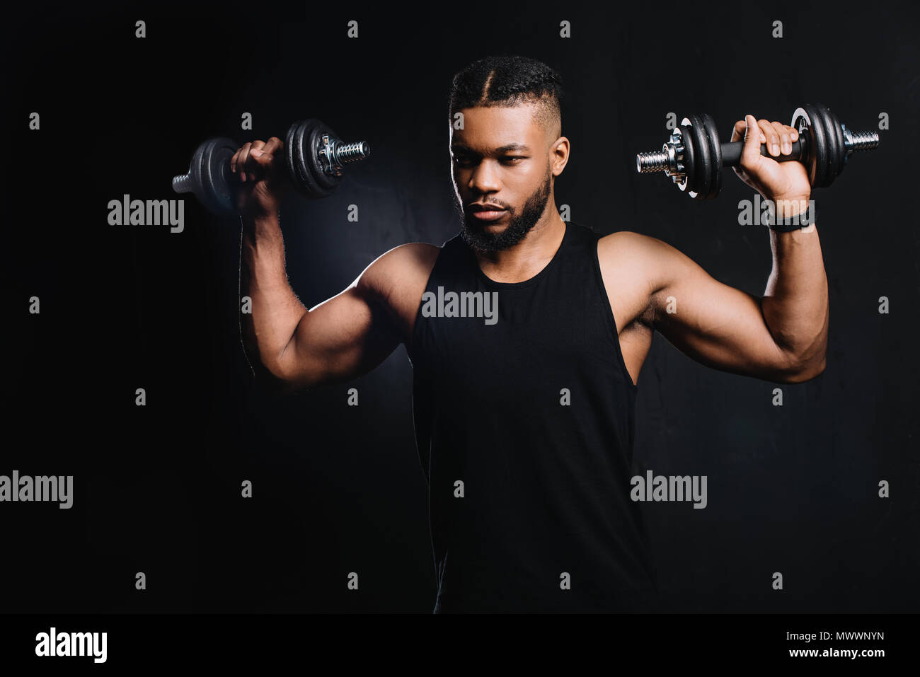 handsome muscular african american man exercising with dumbbells on ...