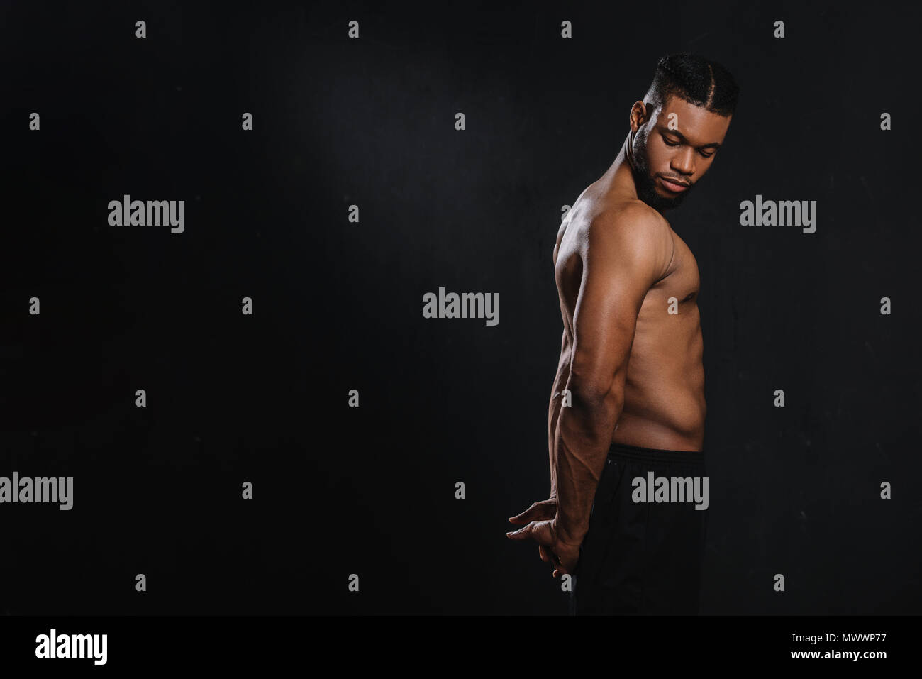 side view of muscular young african american man stretching hands ...