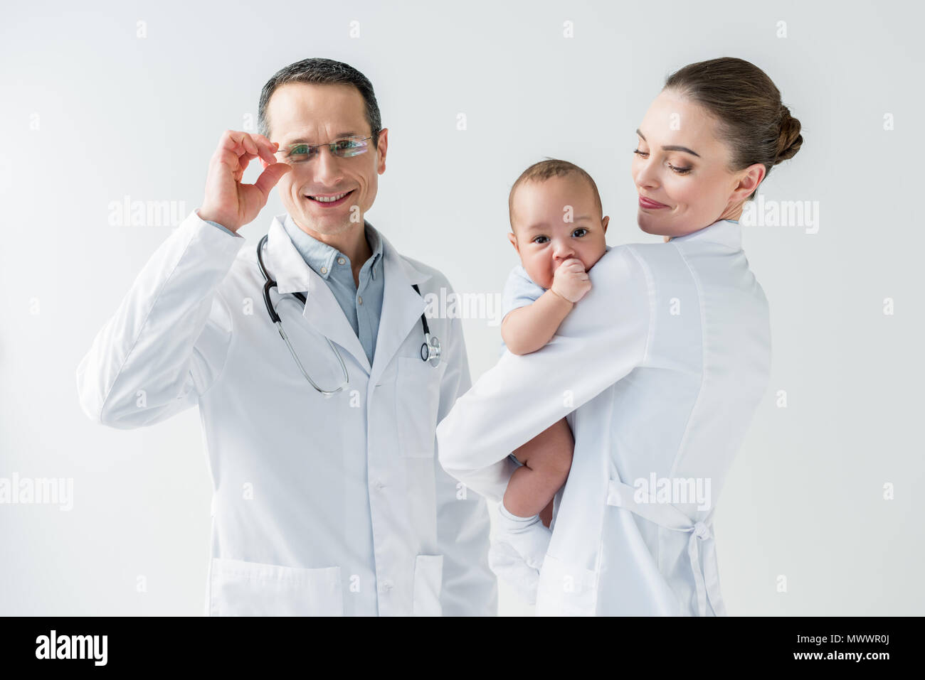 pediatricians with little baby isolated on white Stock Photo - Alamy