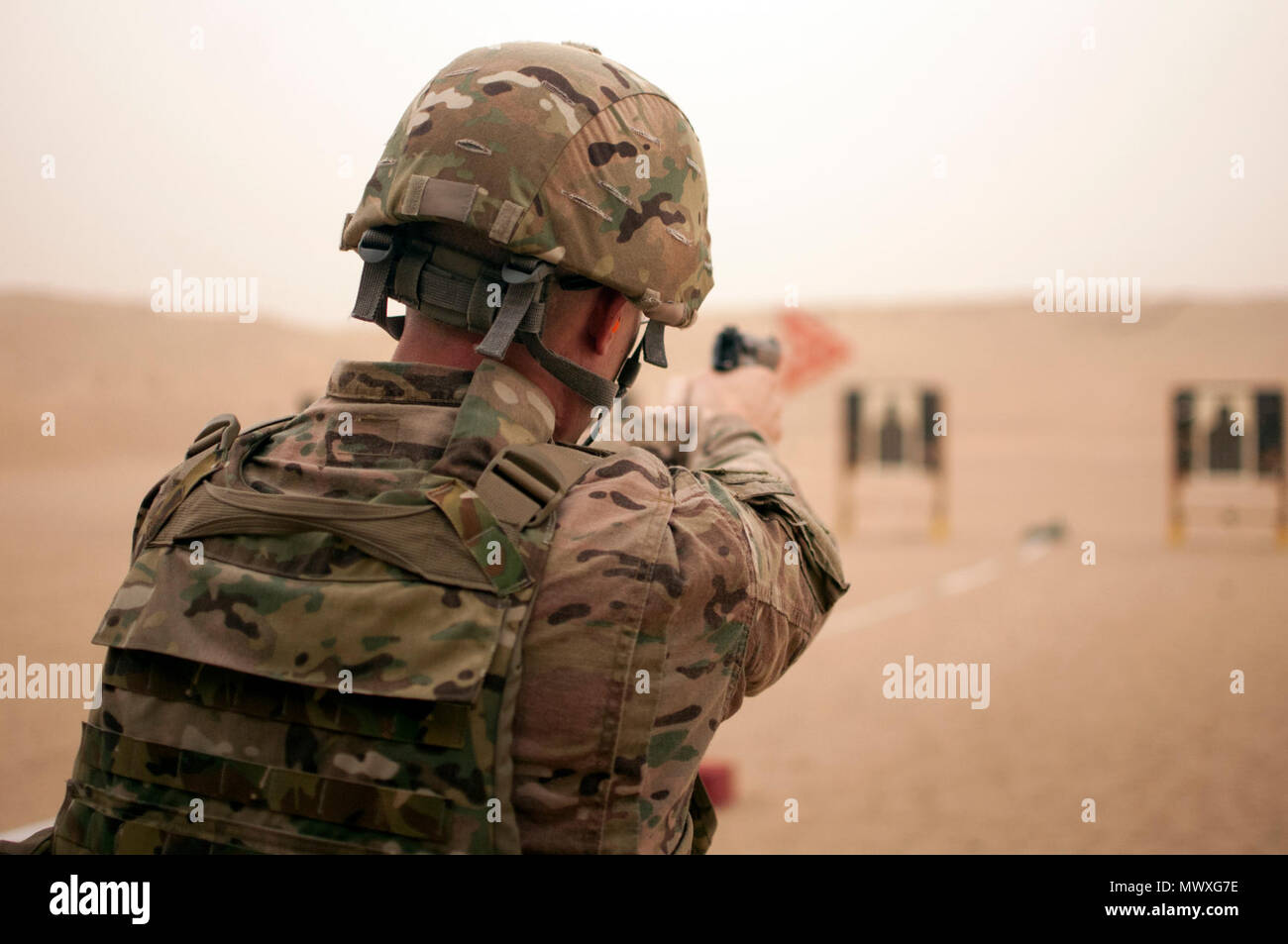 A U.S. Army Central Command Soldier fires the M9 pistol during the ...