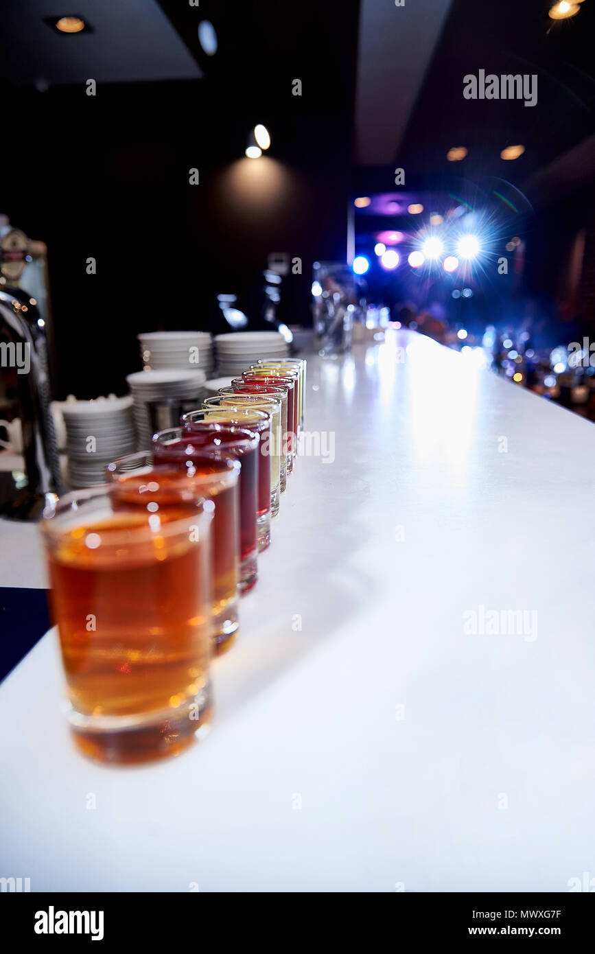 Multicolored alcoholic shots on the bar counter Stock Photo - Alamy