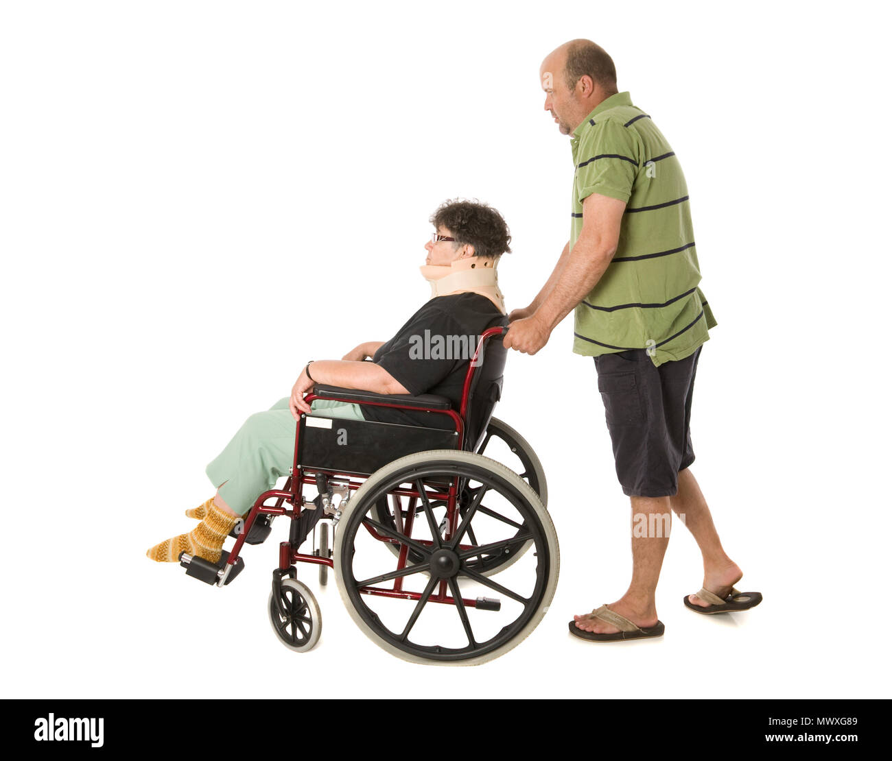 Mature man pushing elderly woman in wheelchair hi-res stock photography ...