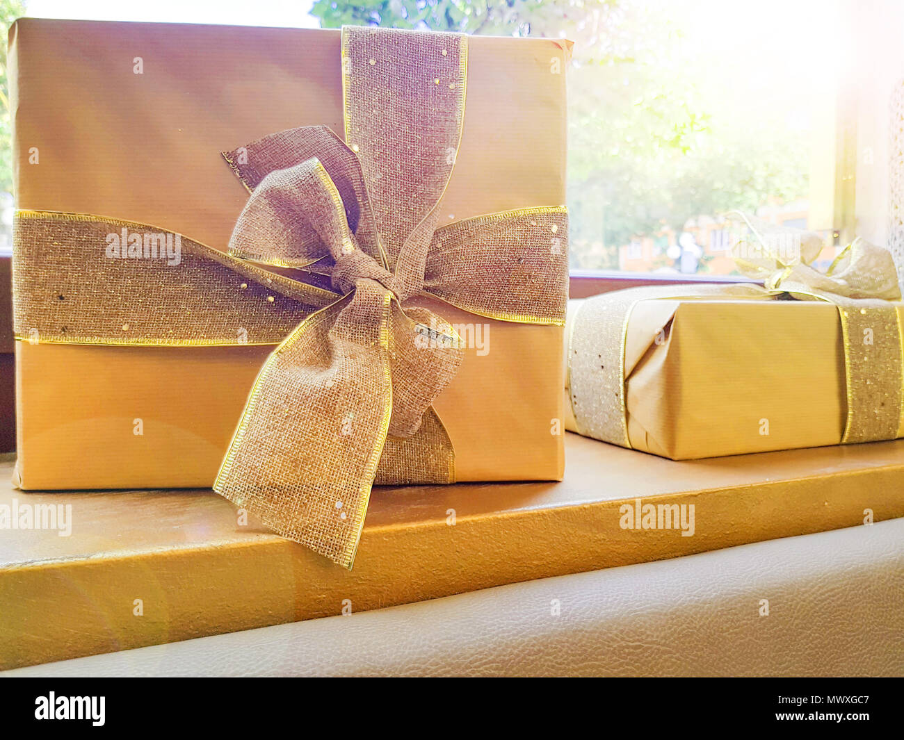 Large brown gift box on the table located by the clear window, Gift box ...