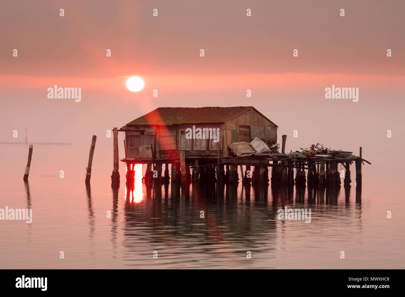 Old fishermen's shack at sunset in Venetian lagoon off the coast of ...