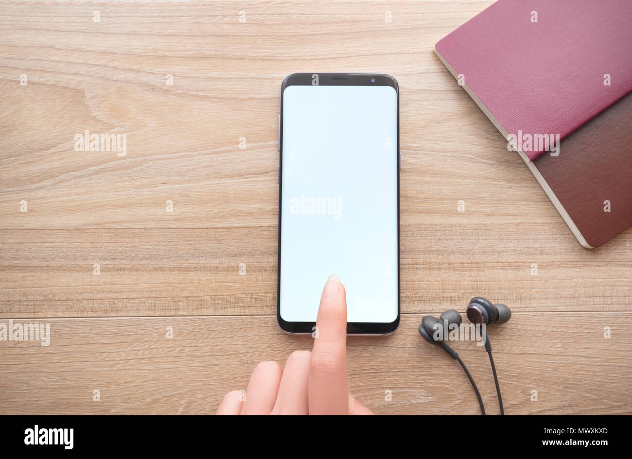 Technology concept, Woman hand holding smartphone on wood table with ... Technology concept, Woman hand holding smartphone on wood table with ...
