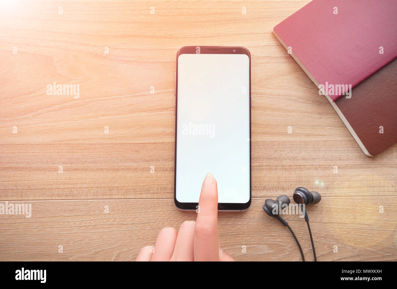 Technology concept, Woman hand holding smartphone on wood table with ...
