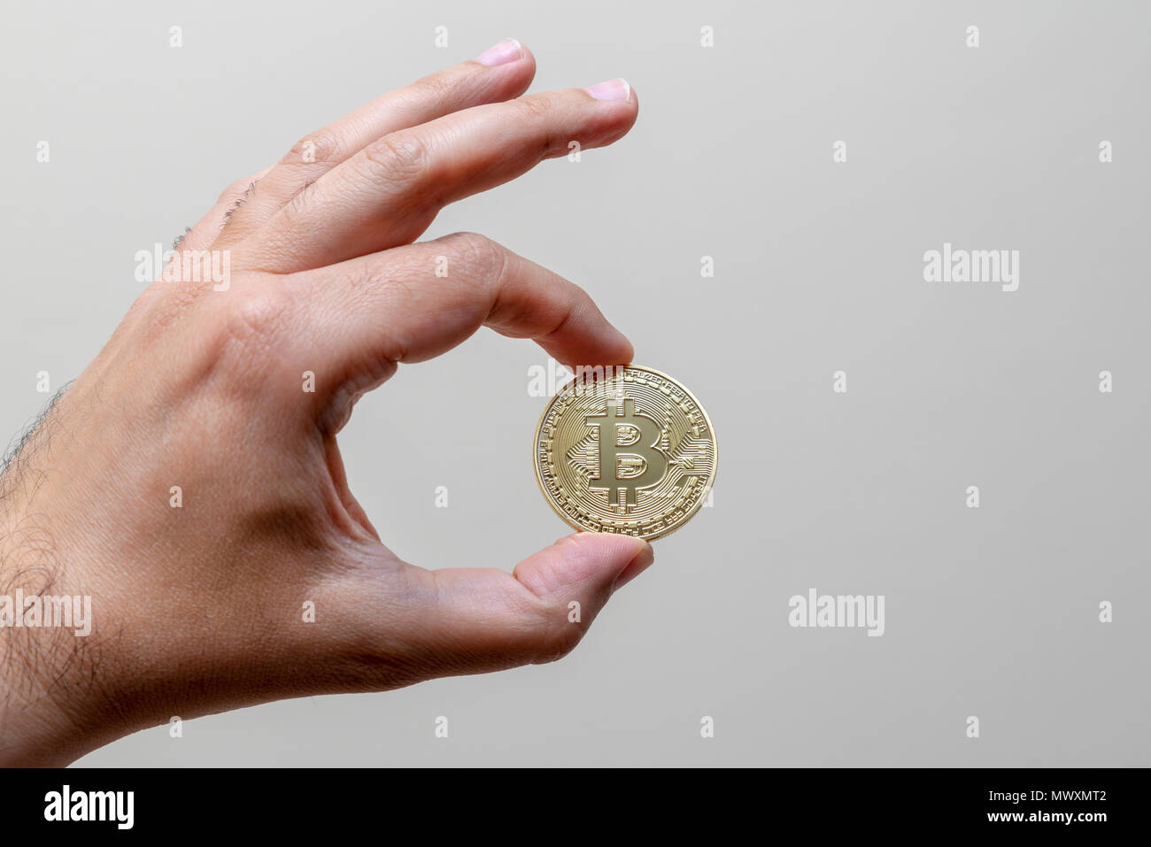 Coin holding human hand fingers hi-res stock photography and images - Alamy