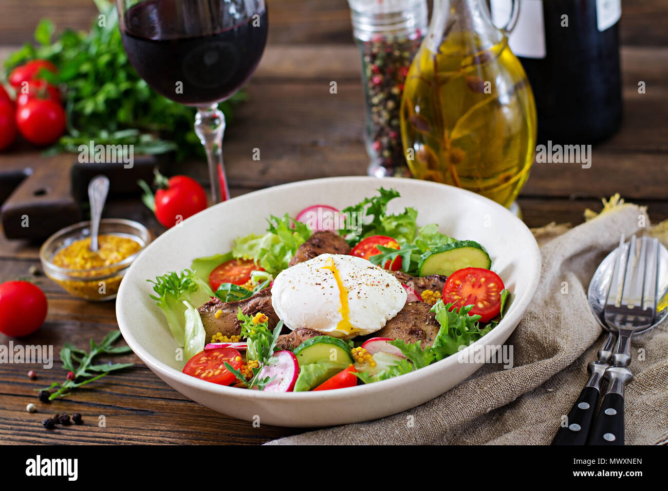 Warm salad from chicken liver, radish, cucumber, tomato and egg poached ...