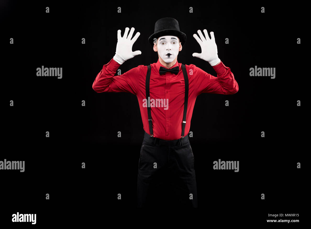 mime with hands up isolated on black Stock Photo - Alamy