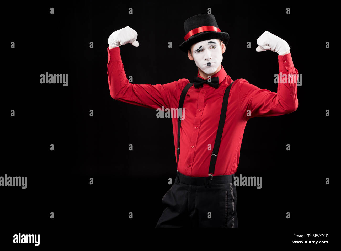 mime showing muscles isolated on black Stock Photo - Alamy