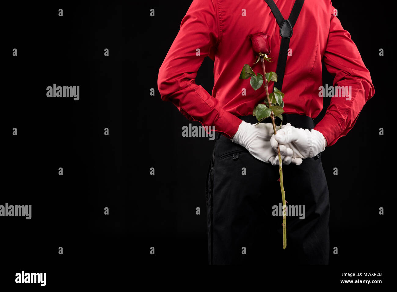 Man hiding rose behind back hi-res stock photography and images - Alamy