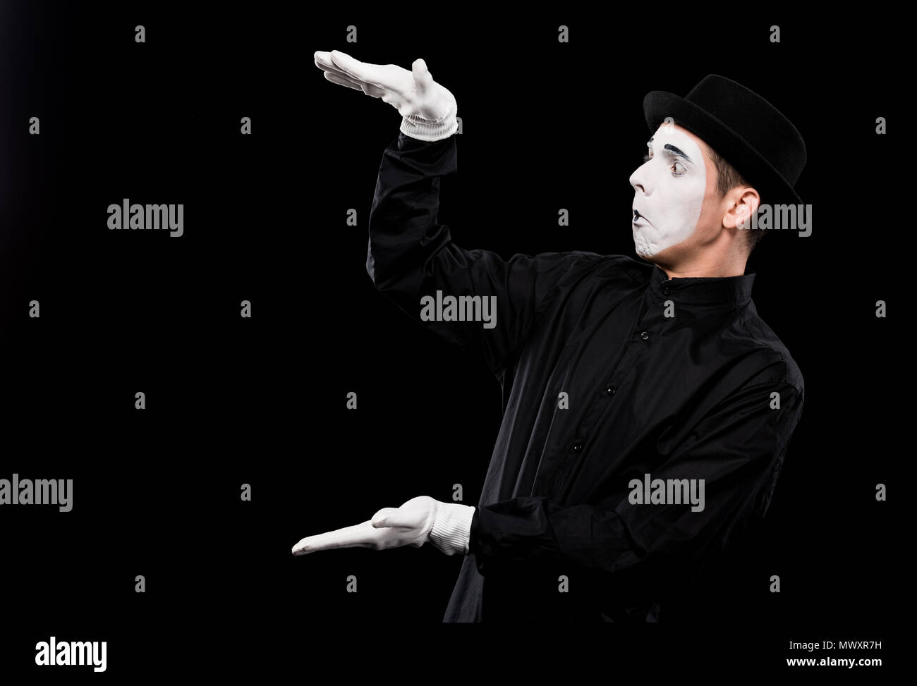 surprised mime showing size of something isolated on black Stock Photo ...