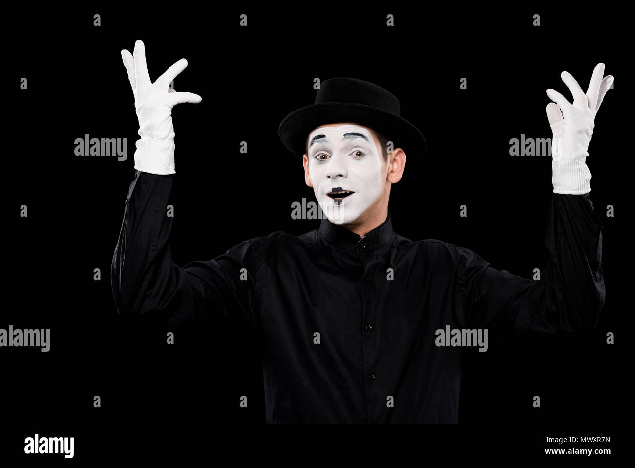 mime showing hands and looking at camera isolated on black Stock Photo ...
