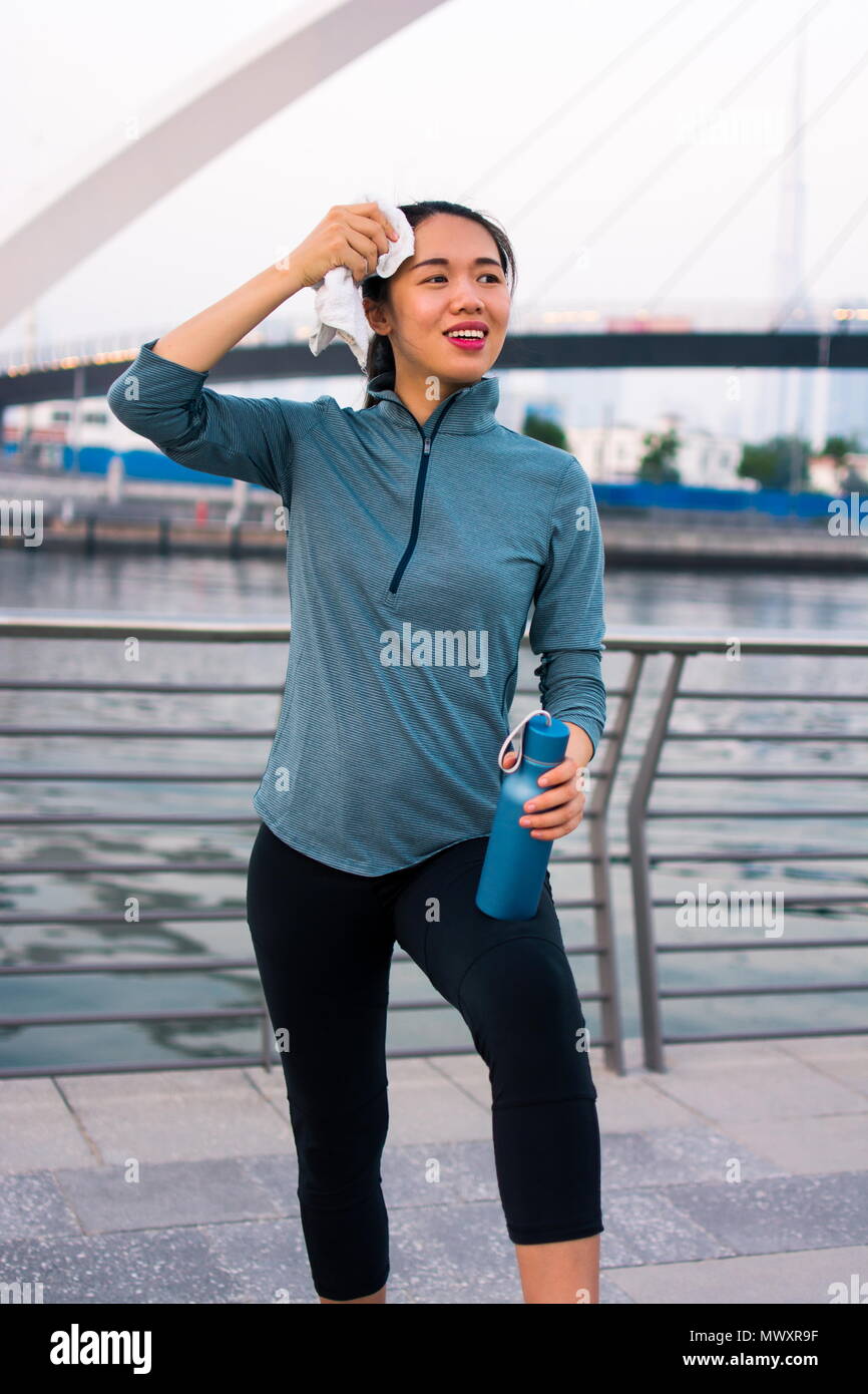 Tired girl wiping out sweat after workout Stock Photo - Alamy