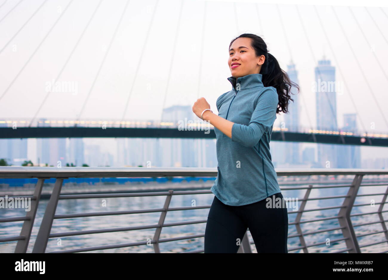 Girl running in a modern city environment, urban runner Stock Photo - Alamy