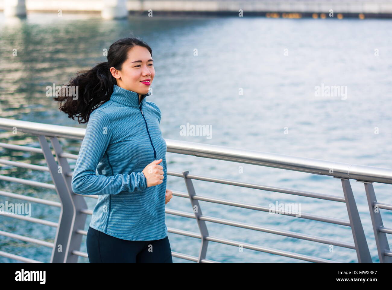 Girl running in a modern city environment, urban runner Stock Photo - Alamy