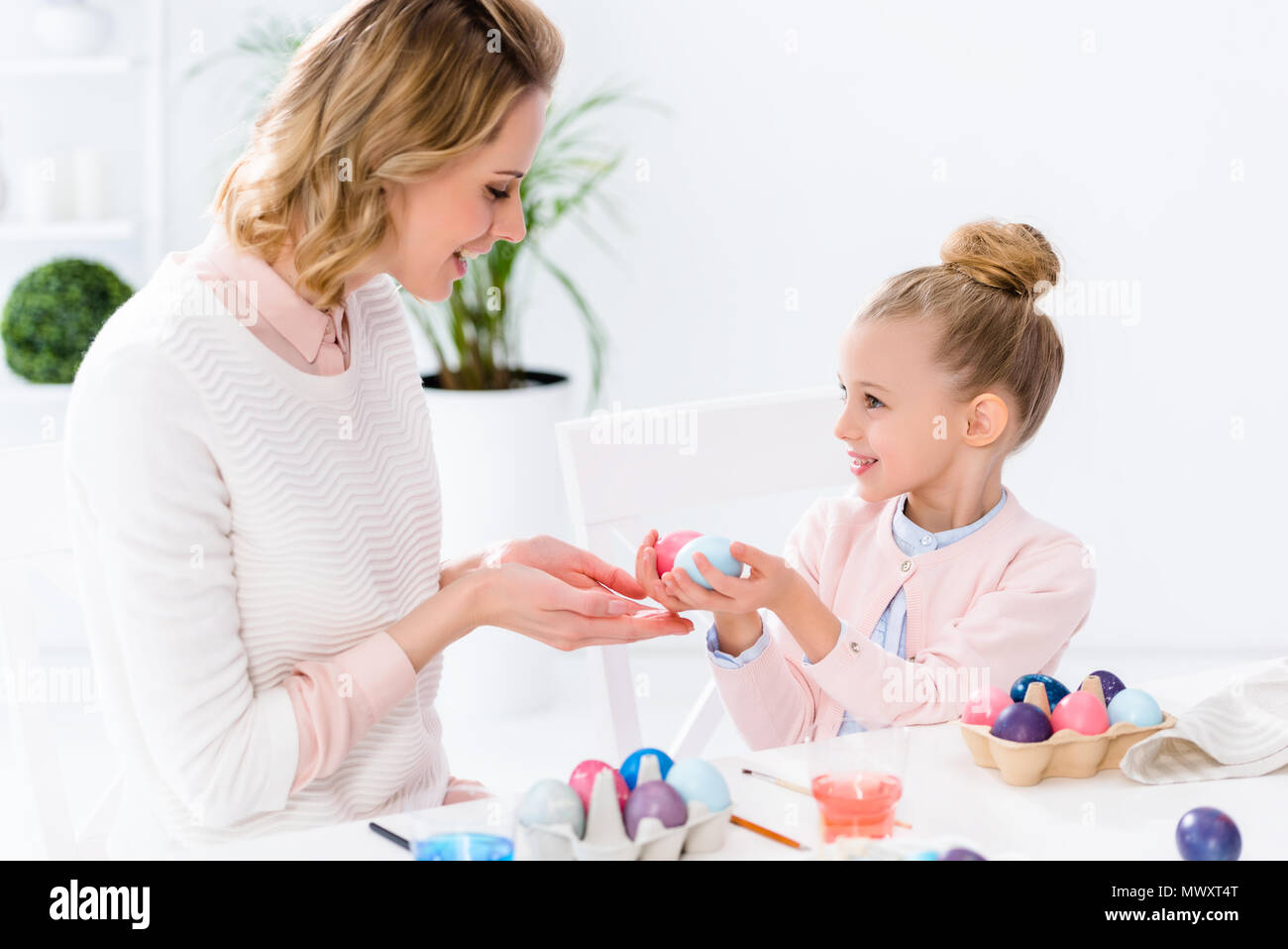 Kid girl giving mother Easter eggs Stock Photo - Alamy
