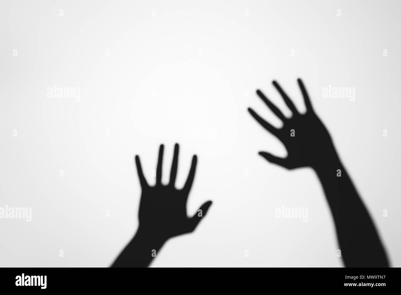 spooky mysterious shadows of human hands on grey Stock Photo - Alamy
