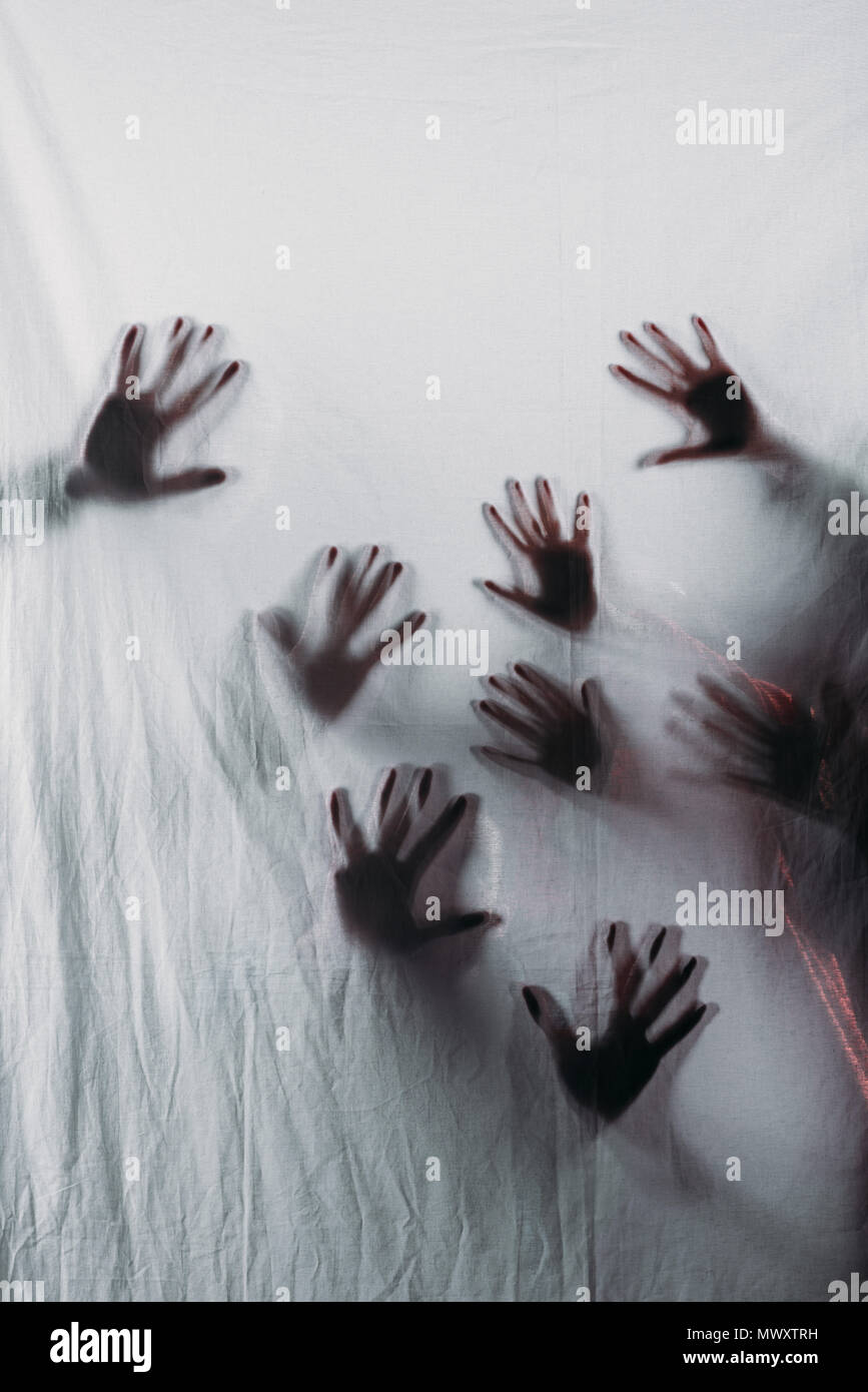 blurry scary silhouettes of human hands touching frosted glass Stock ...