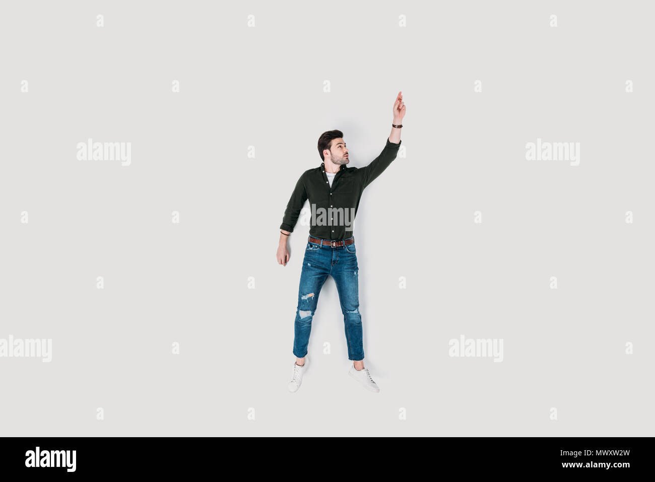 top view of handsome young man pointing up isolated on white Stock ...
